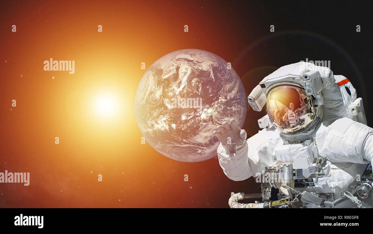 Asteronaut in outer space and Blue planet Earth and the Sun. Elements ...