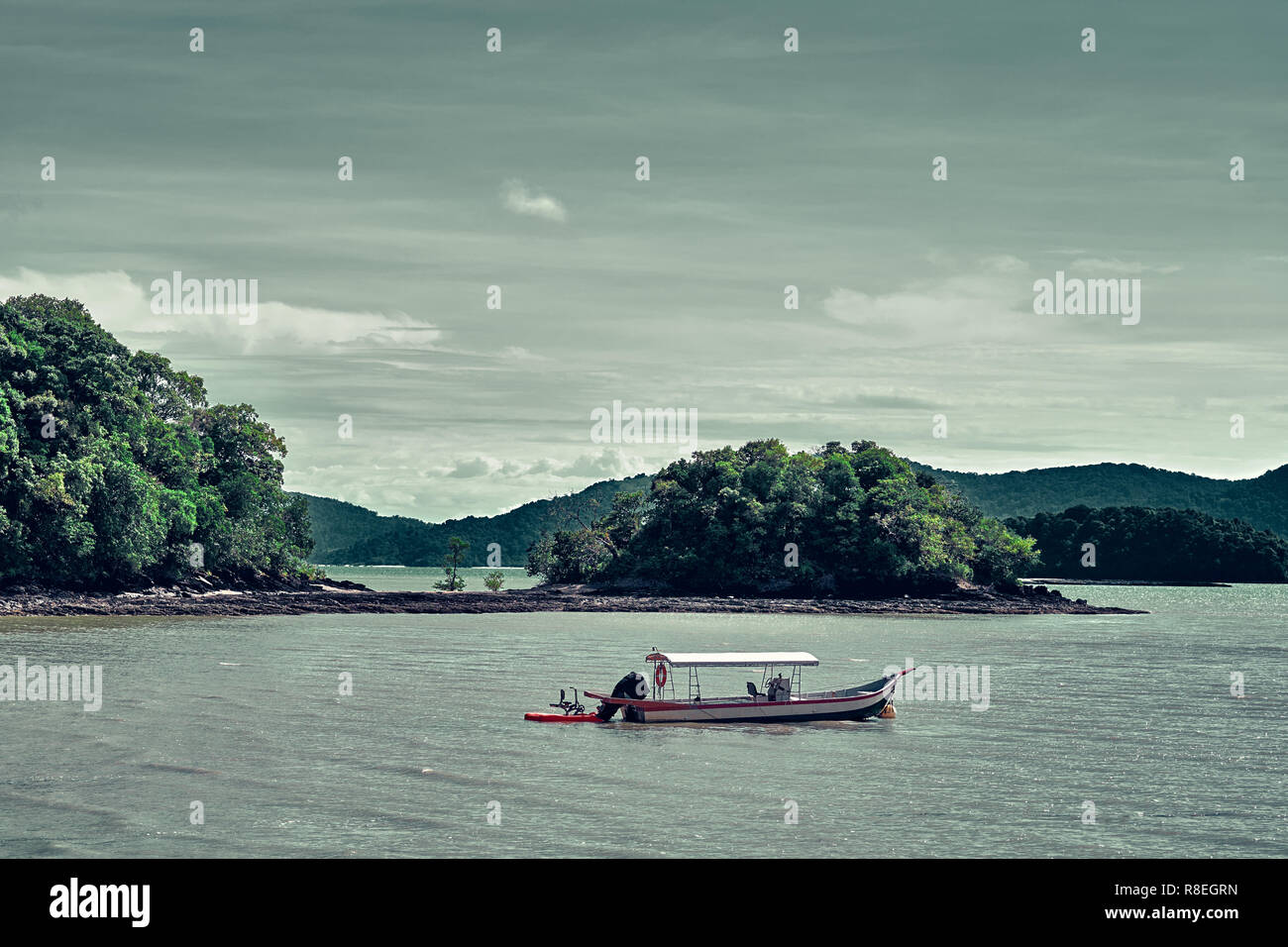 Boat on the sea. Green color toning photo Stock Photo - Alamy