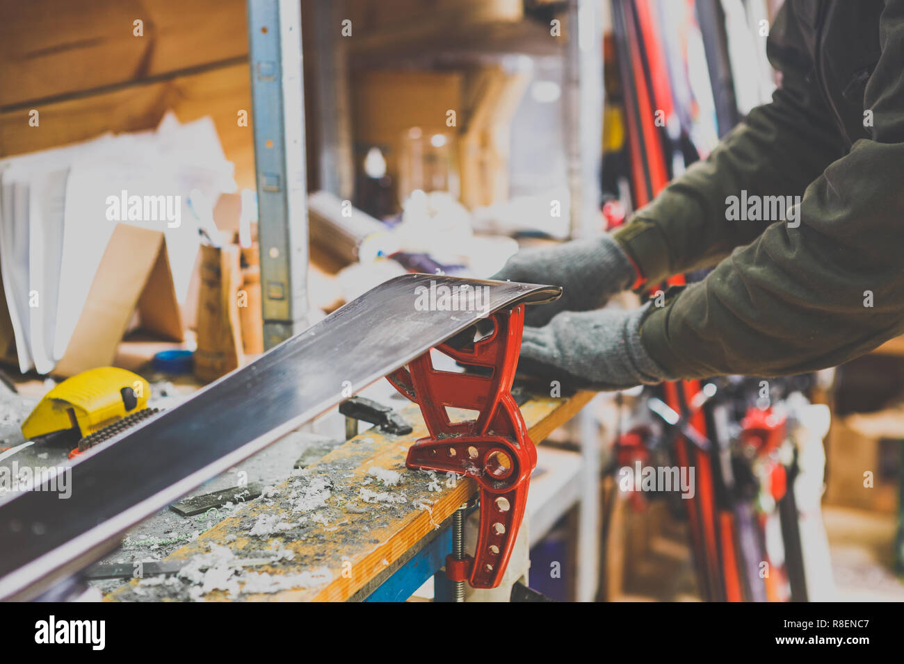 Theme repairs and maintenance of skis. The male worker is repairing ...