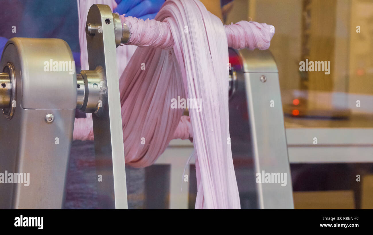 Making purple salt water taffy in small candy shop Stock Photo - Alamy