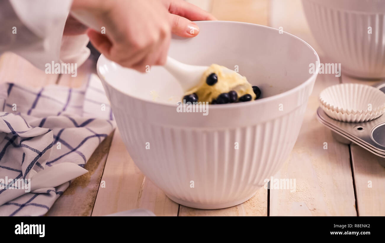 Mixing ingredients together in mixing bowl for blueberry muffins Stock ...