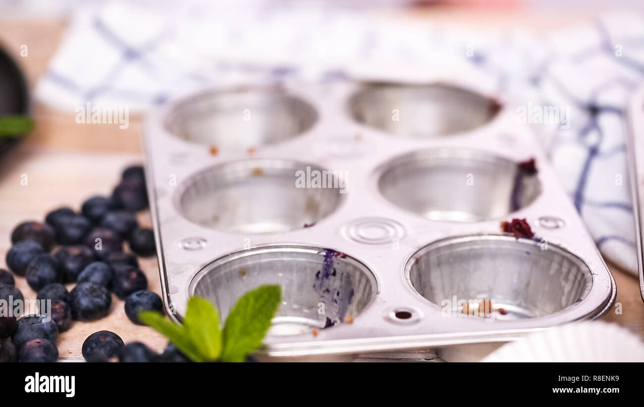 Taking blueberry muffins out of metal muffin pan Stock Photo - Alamy