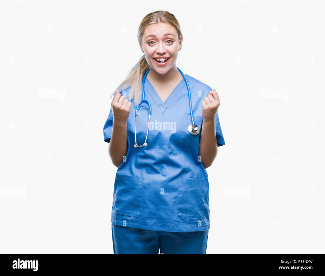 Young blonde surgeon doctor woman over isolated background celebrating ...
