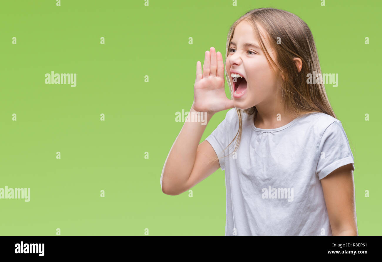 Young beautiful girl over isolated background shouting and screaming ...