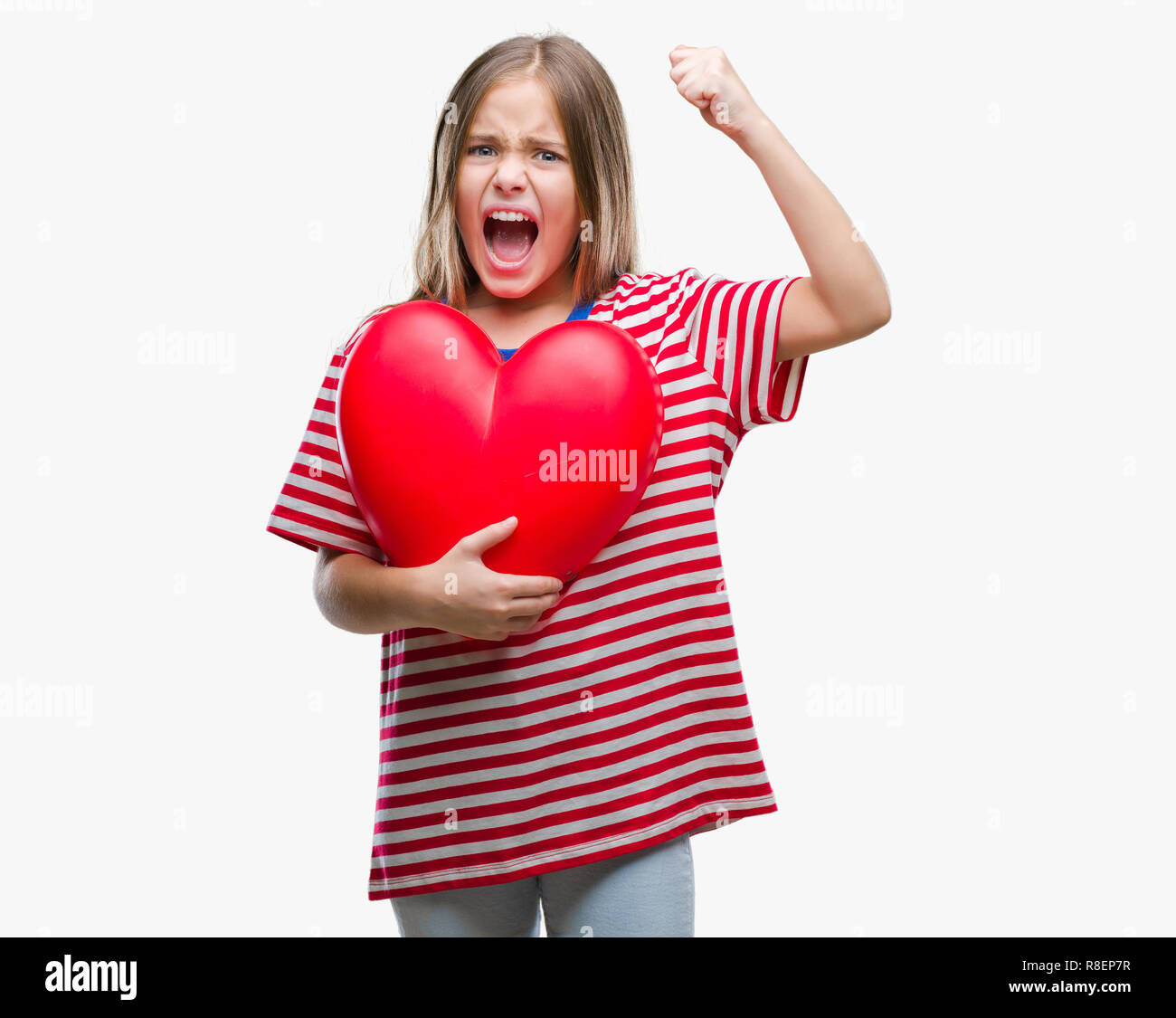 Young beautiful girl holding red heart over isolated background annoyed ...