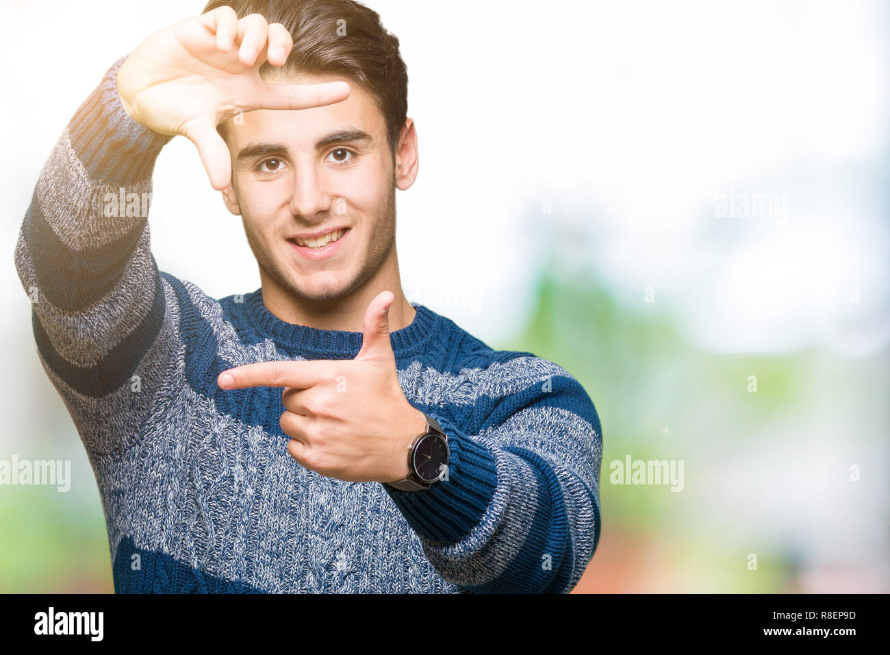 Young handsome man over isolated background smiling making frame with ...