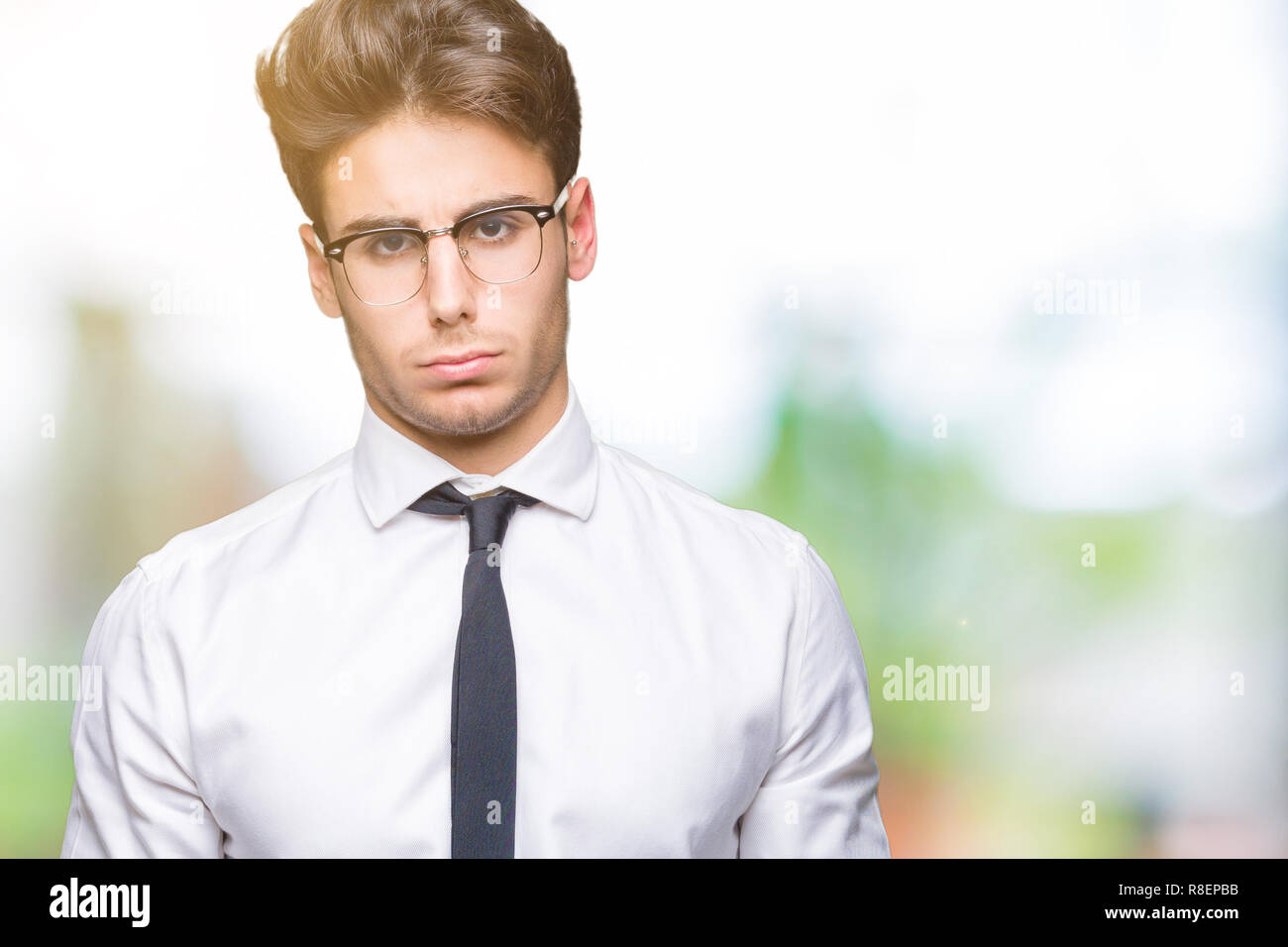 Young business man wearing glasses over isolated background depressed ...