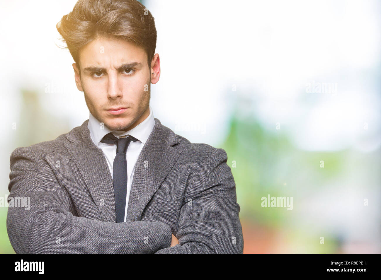Young business man wearing suit and tie over isolated background ...