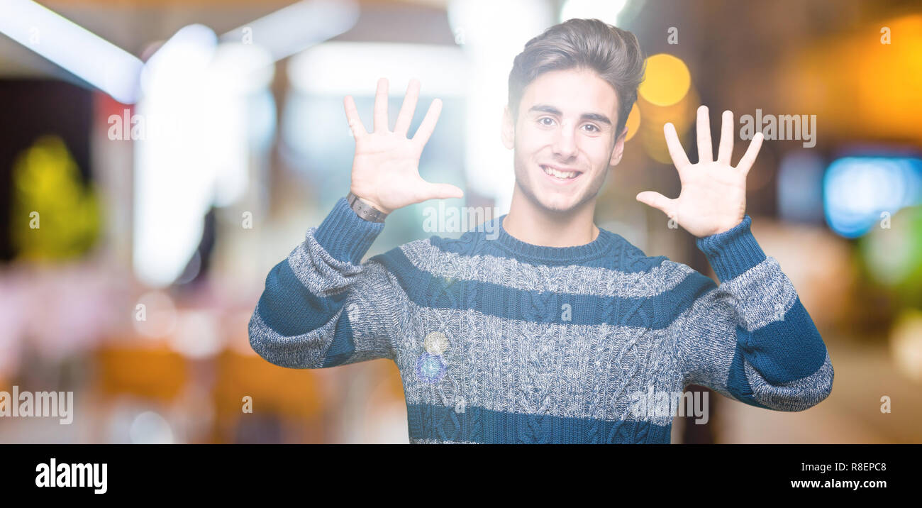 Young handsome man over isolated background showing and pointing up ...