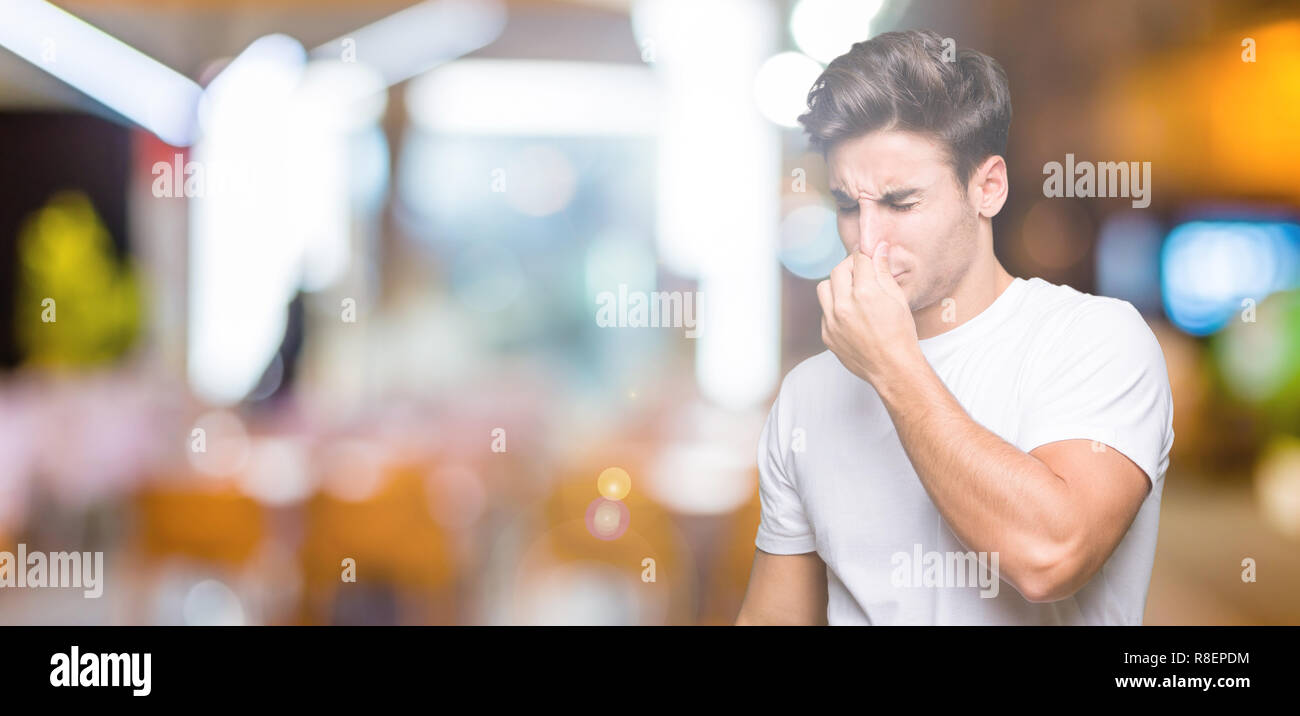 Young handsome man wearing white t-shirt over isolated background ...