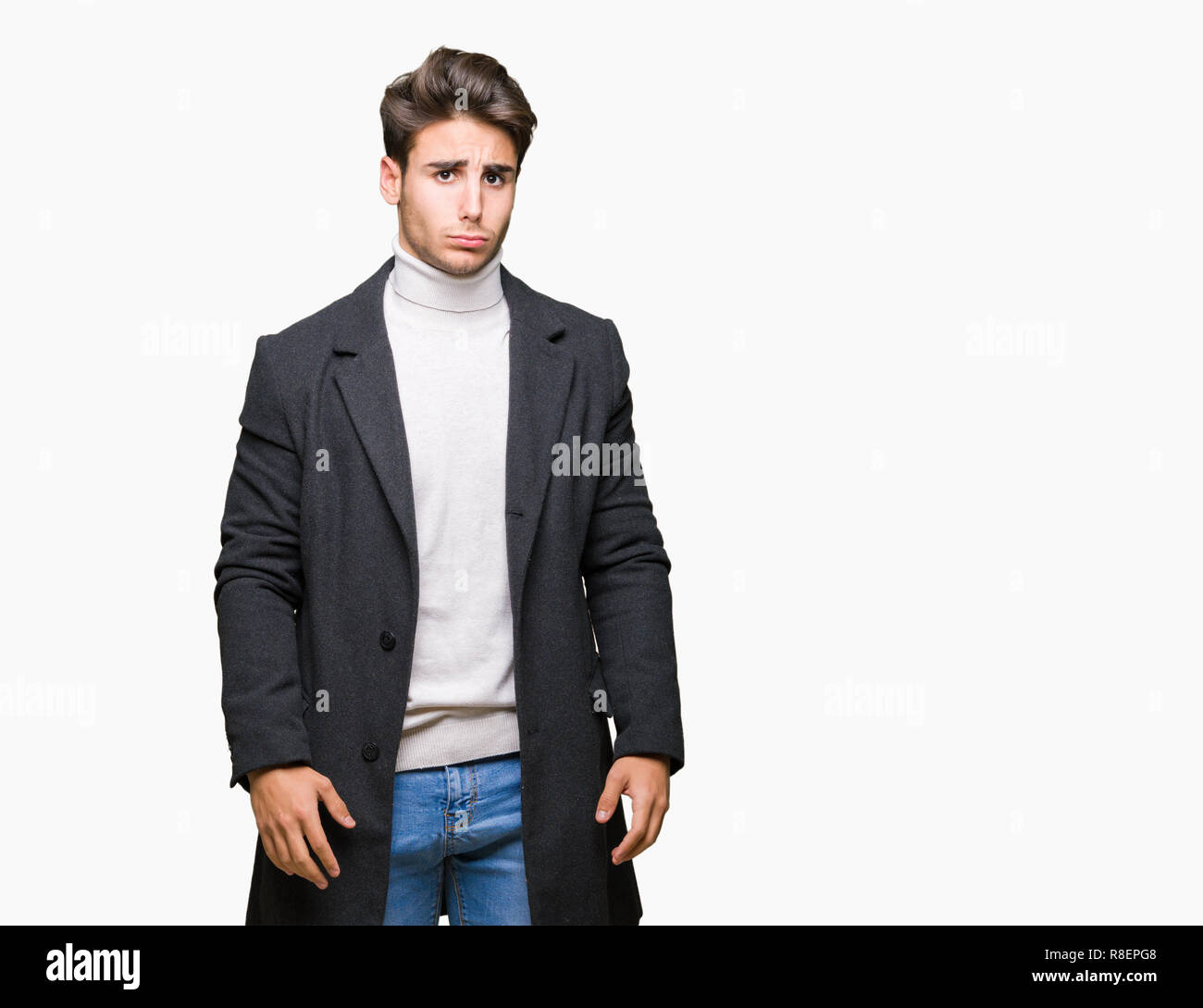 Young elegant man wearing winter coat over isolated background ...