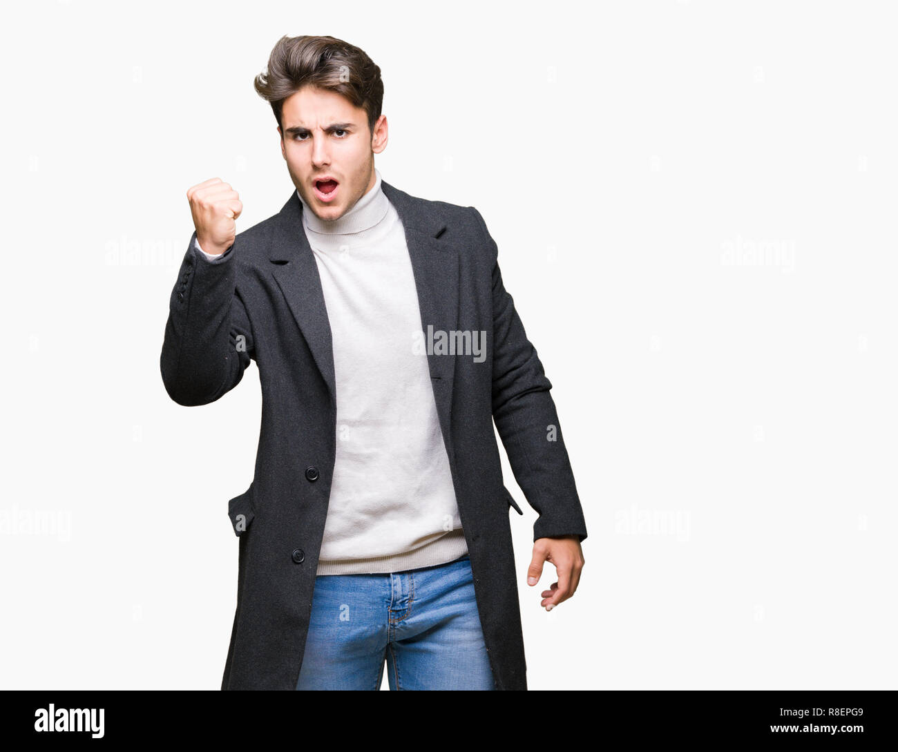 Young elegant man wearing winter coat over isolated background angry ...