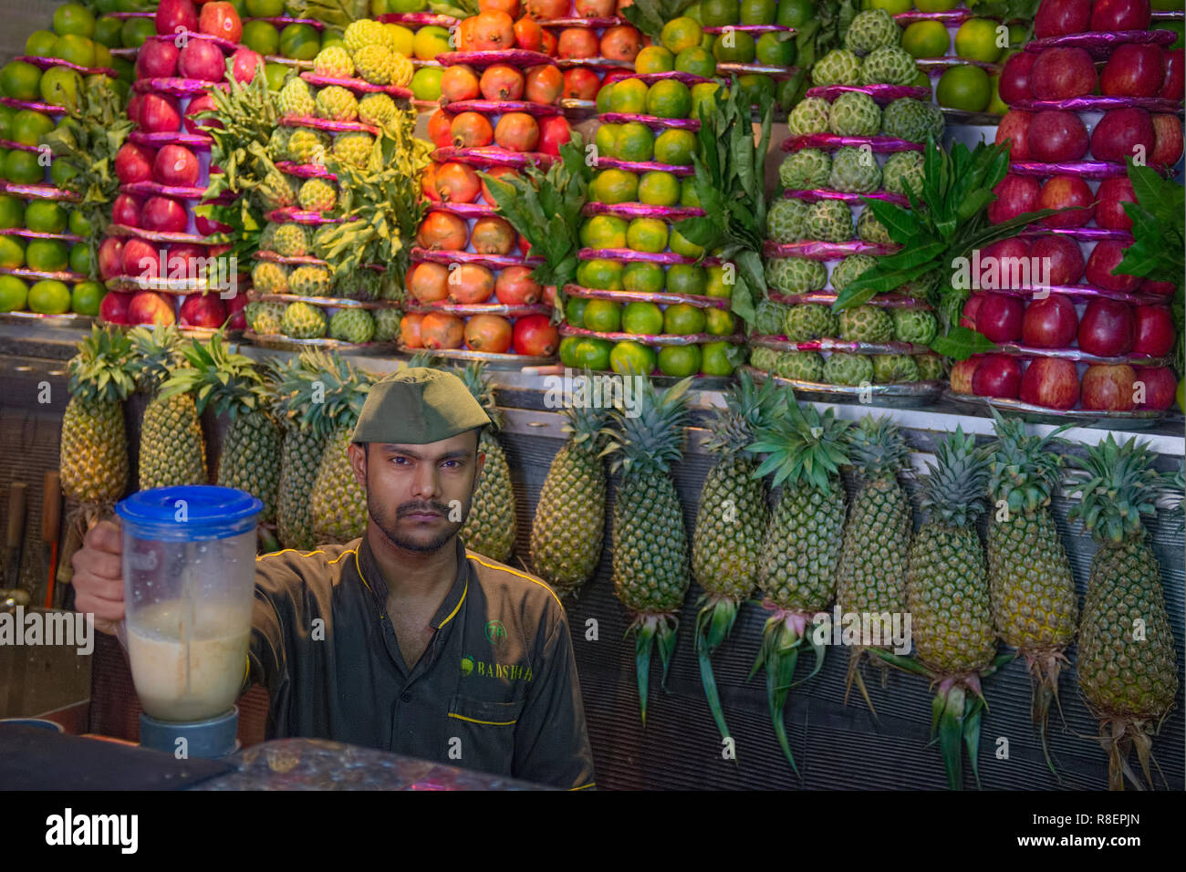 An employee at Badshah Cold Drink House in Mumbai, India, preparing a ...