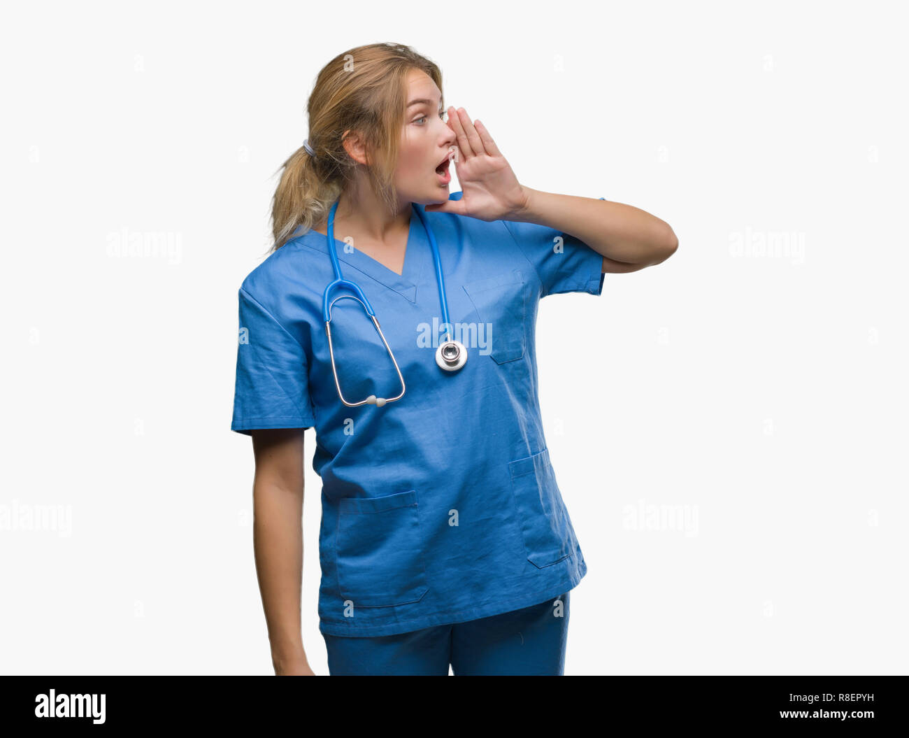 Young caucasian doctor woman wearing surgeon uniform over isolated ...