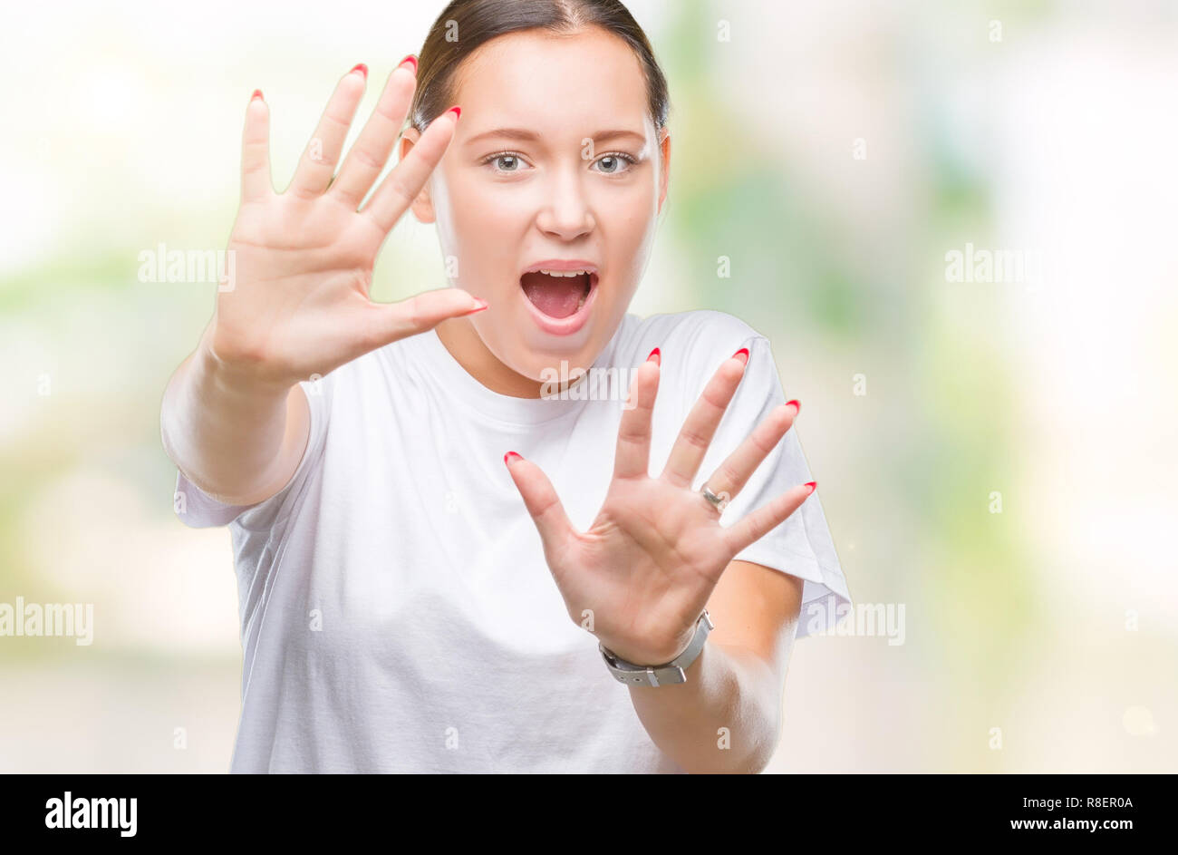 Young beautiful caucasian woman over isolated background afraid and ...
