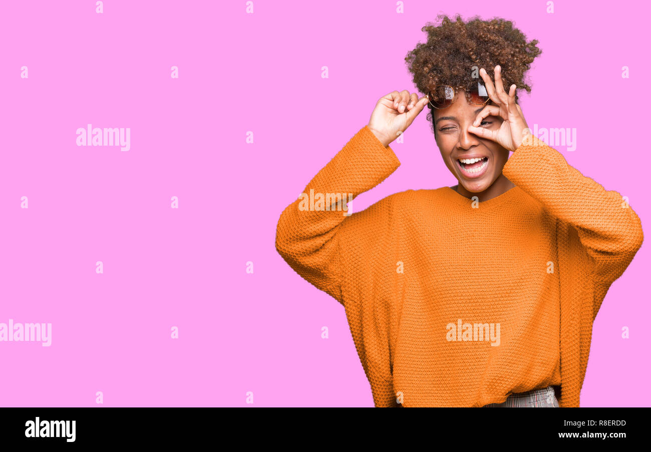 Beautiful young african american woman wearing sunglasses over isolated ...