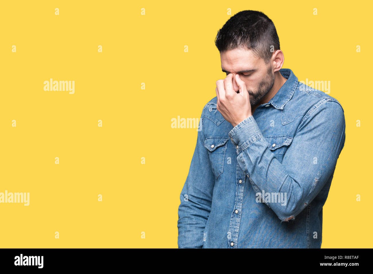 Young handsome man over isolated background tired rubbing nose and eyes ...