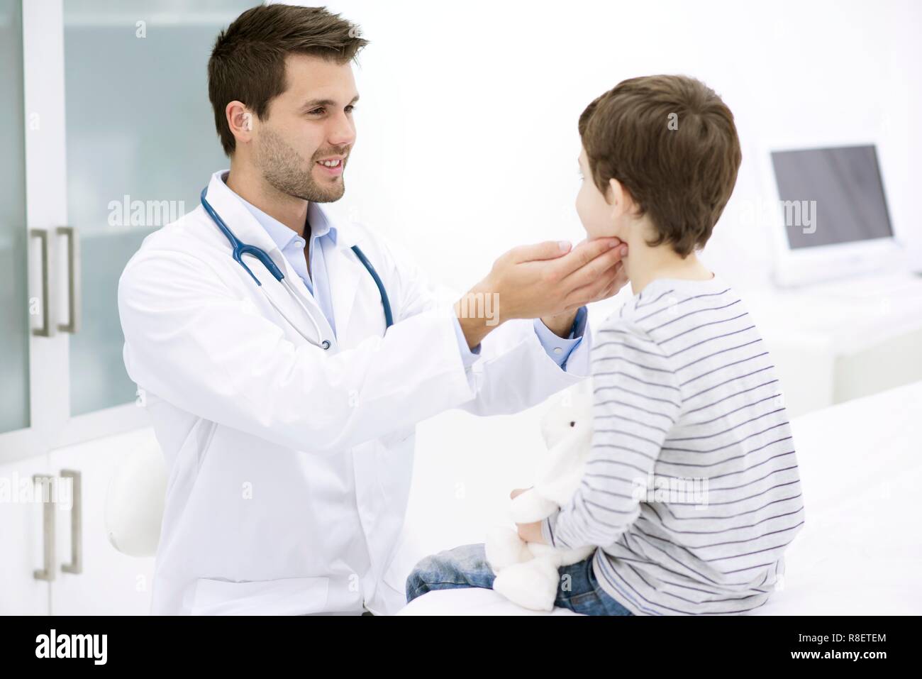 Doctor examining child glands hi-res stock photography and images - Alamy