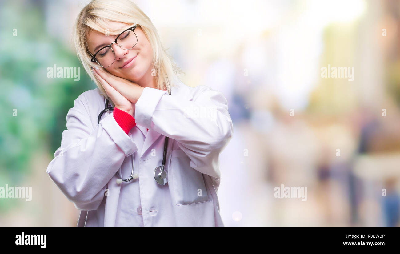 Young beautiful blonde doctor woman wearing medical uniform over ...