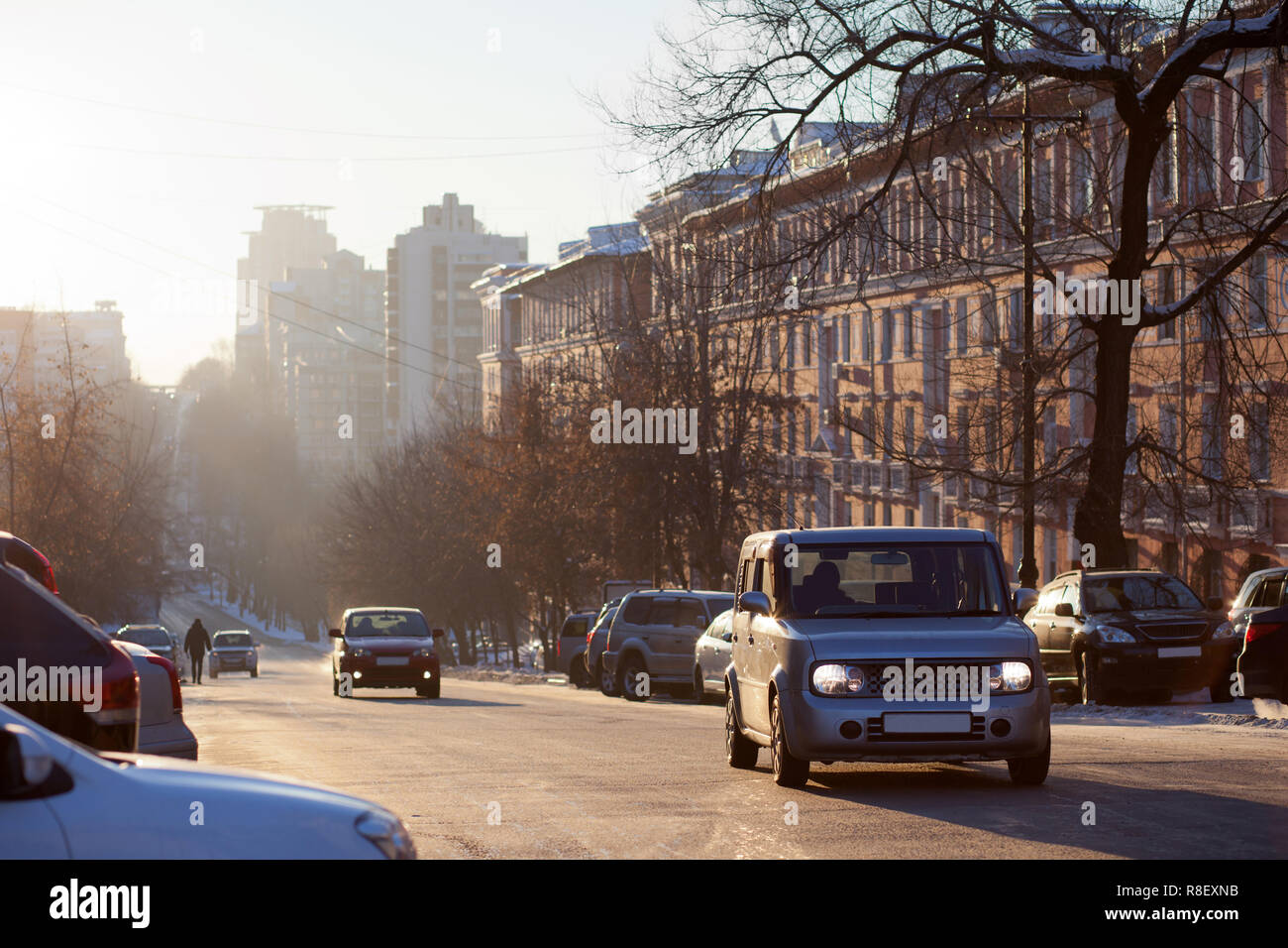 Cars on an ice city winter road Stock Photo - Alamy