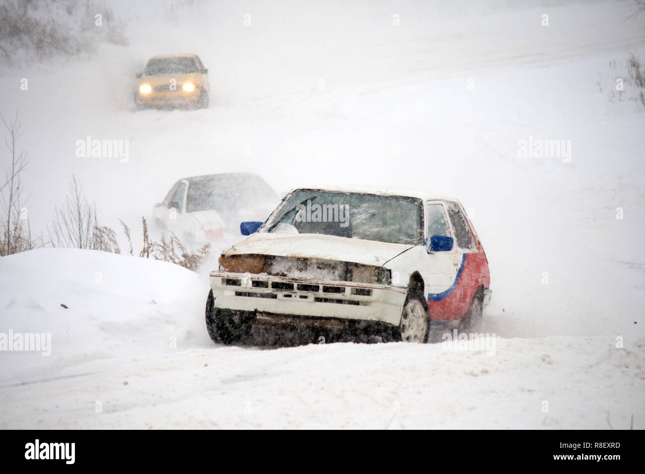 Cars riding a winter race Stock Photo - Alamy