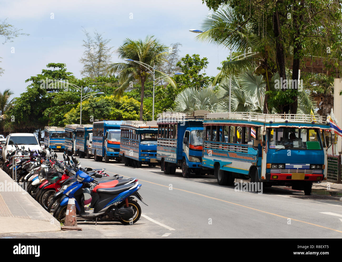 Blue local bus and motorbikes in Phuket Thailand Stock Photo - Alamy
