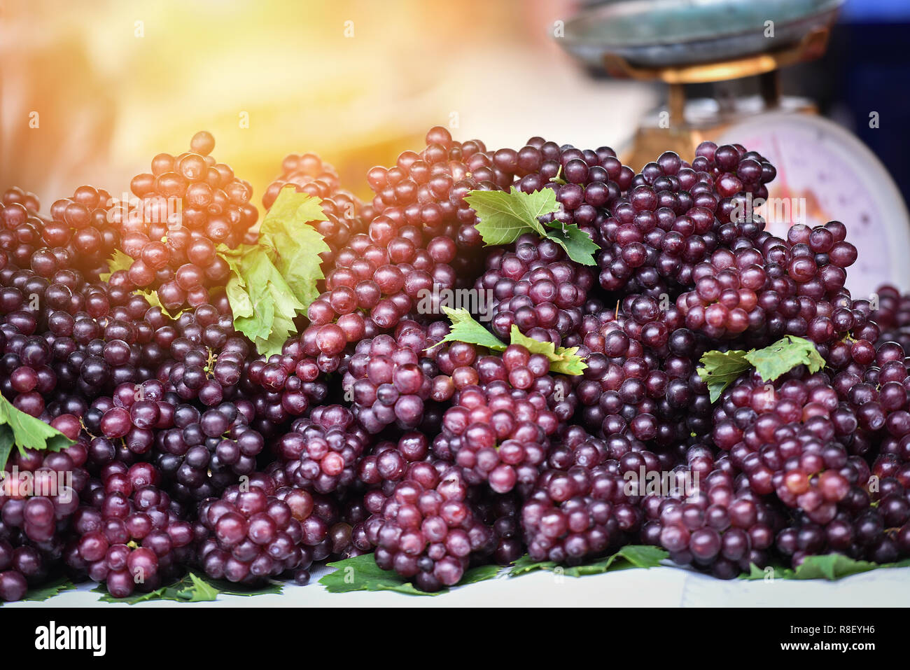 fresh red grape / pile of ripe red grape on bunches and leaf on market ...