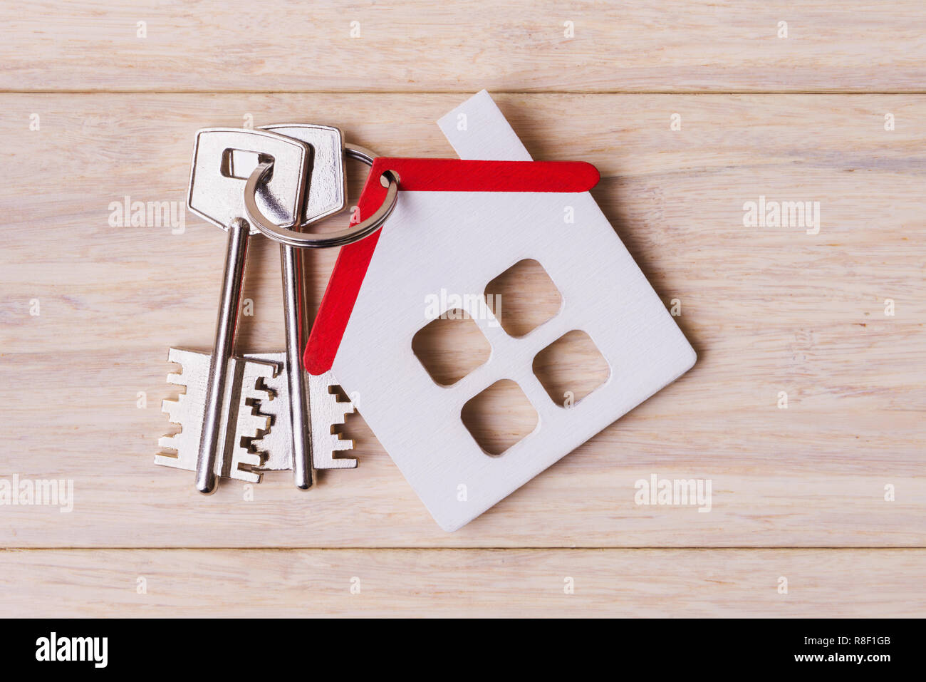 House model with keys over light wooden background Stock Photo - Alamy