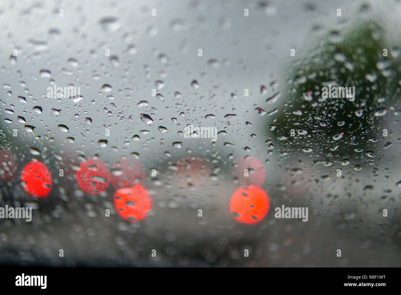 Rain drop on the car glass background.Road view through car window with ...