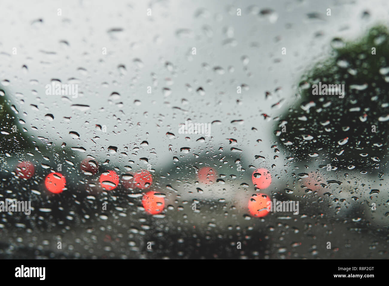 Rain drop on the car glass background.Road view through car window with ...