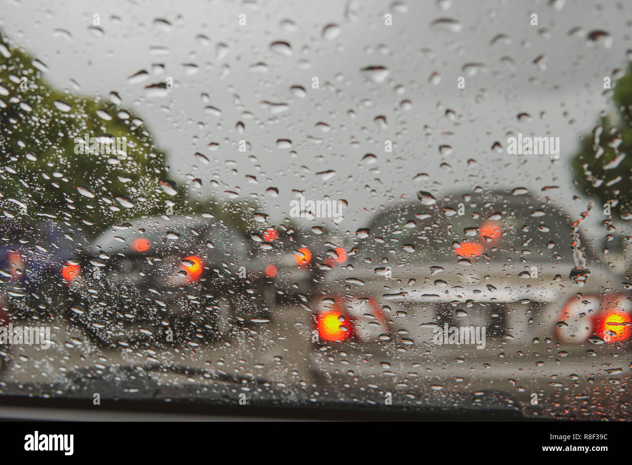Rain drop on the car glass background.Road view through car window with ...