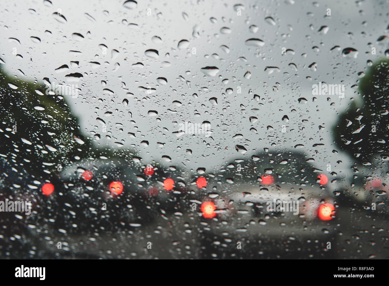 Rain drop on the car glass background.Road view through car window with ...