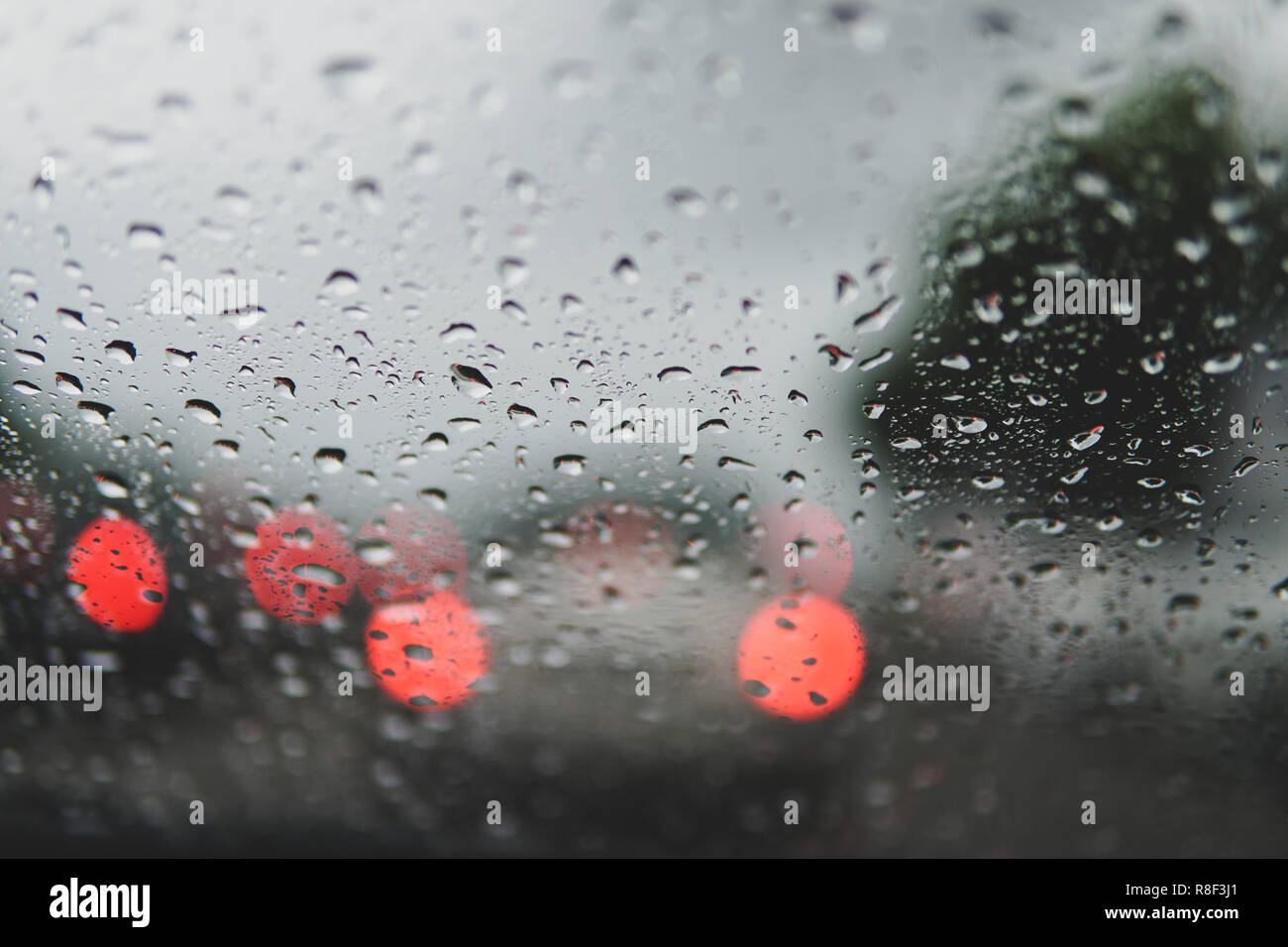 Rain drop on the car glass background.Road view through car window with ...