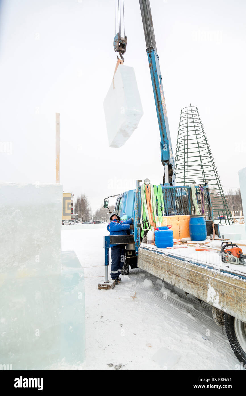 The crane driver raised the ice panel high above the ground Stock Photo ...