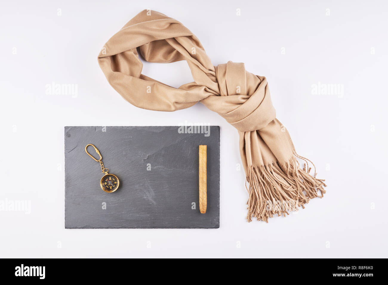 Scarf is tied in beautiful knot, cigar and compass on white background ...