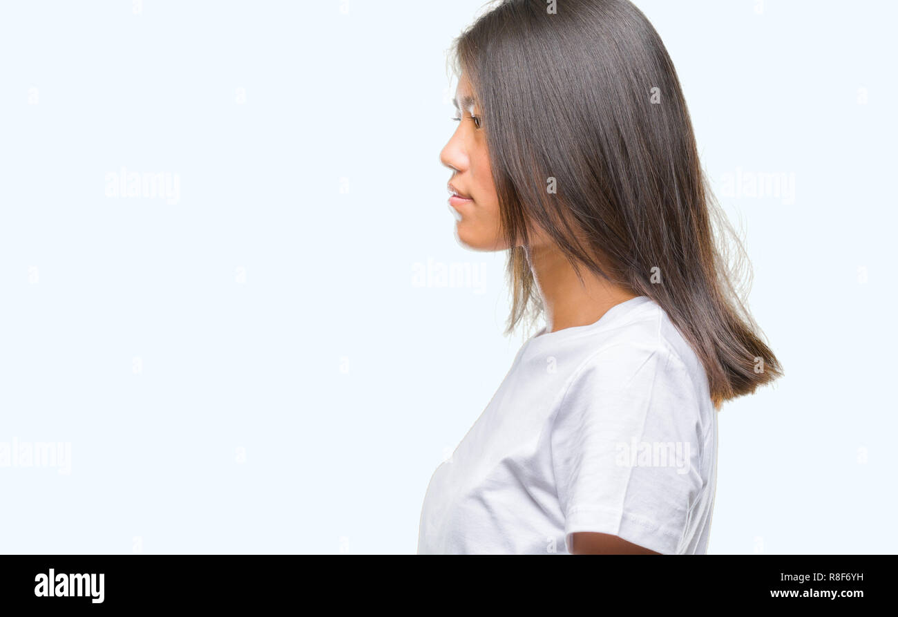 Young asian woman over isolated background looking to side, relax ...