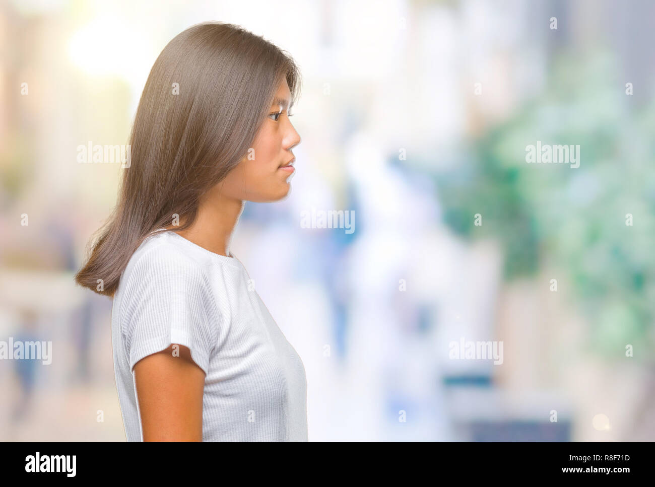 Young asian woman over isolated background looking to side, relax ...