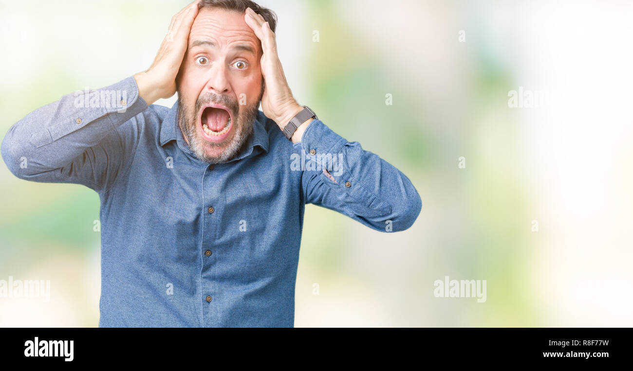 Handsome middle age elegant senior man over isolated background Crazy ...