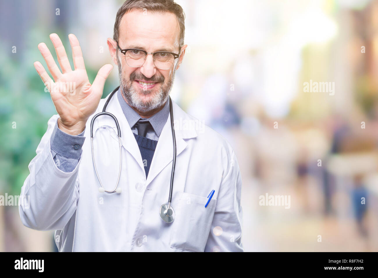 Middle age senior hoary doctor man wearing medical uniform isolated ...