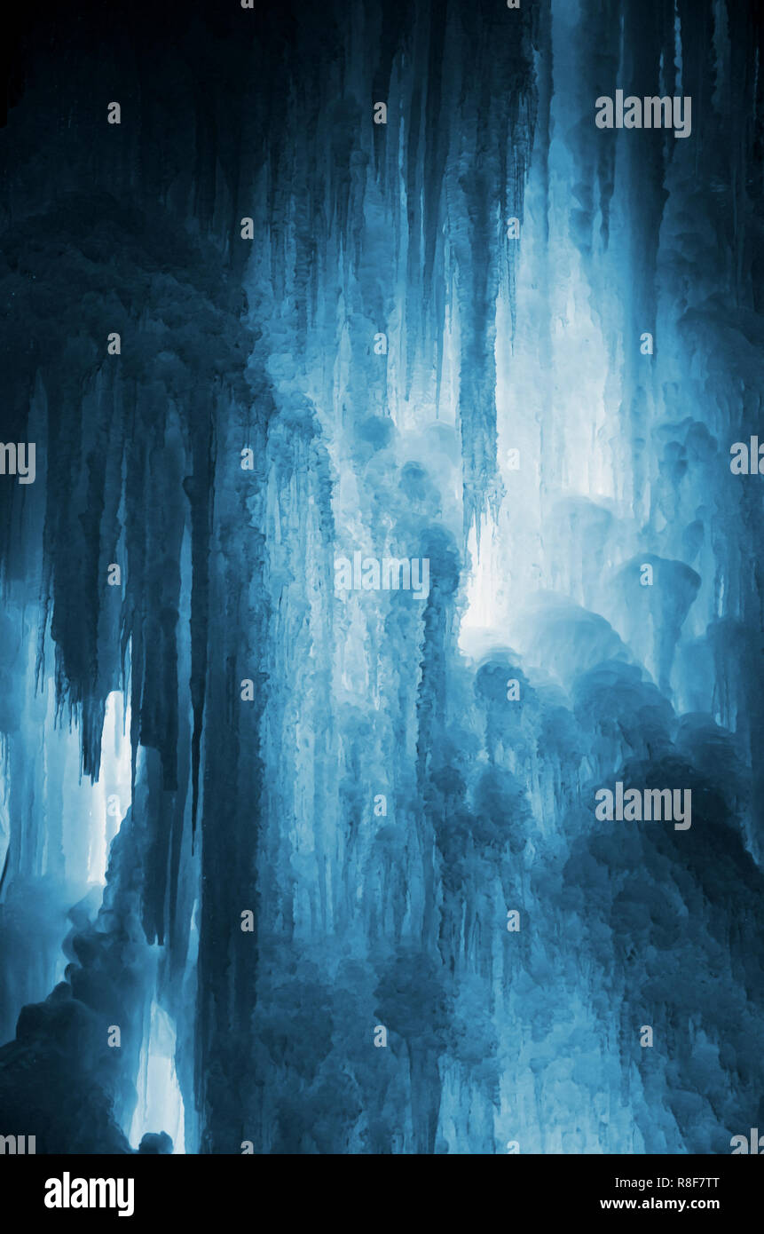 Huge ice icicles. Large blocks of ice frozen waterfall or water. Blue ...