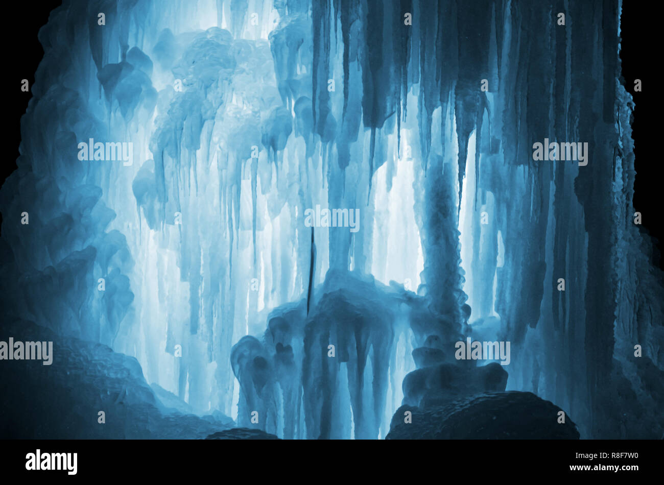 Huge ice icicles. Large blocks of ice frozen waterfall or water. Blue ...
