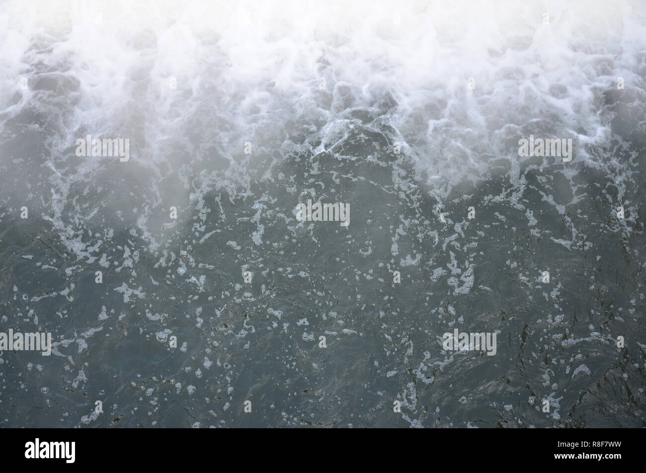 Dam to regulate the water level in the river. Falling water monochrome ...