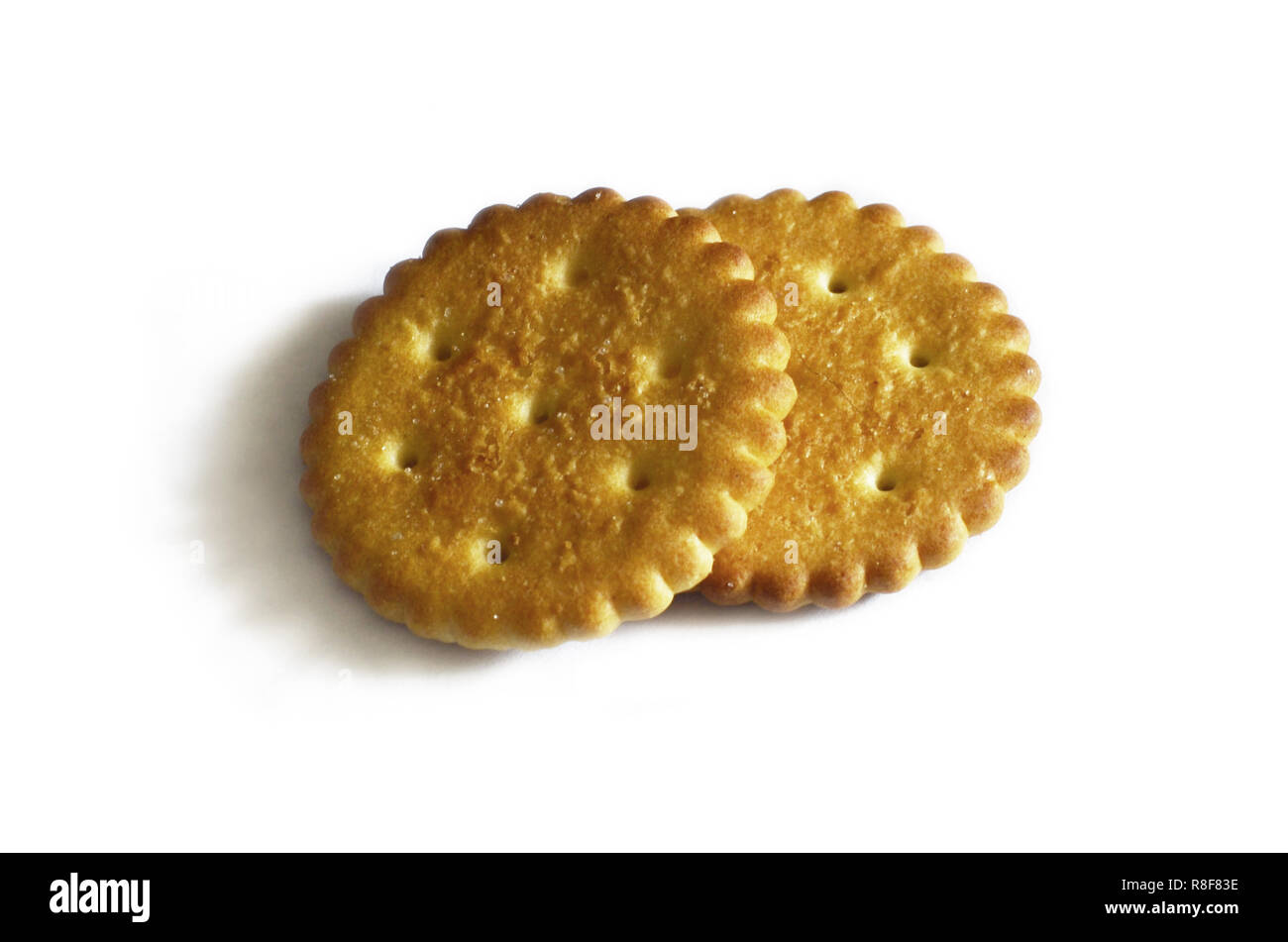 Classic round golden yellow salted cracker isolated on over white ...