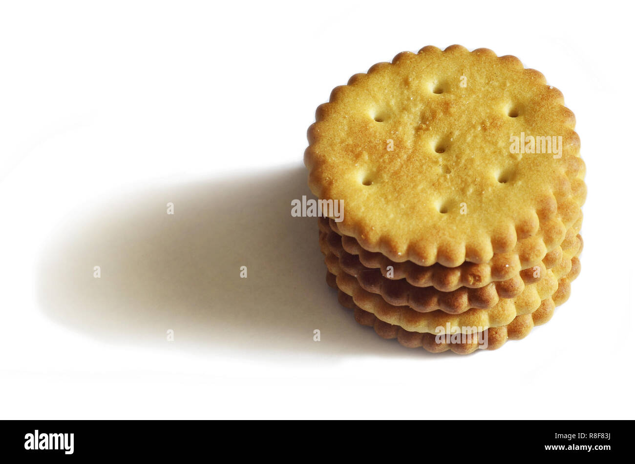 Classic round golden yellow salted cracker isolated on over white ...