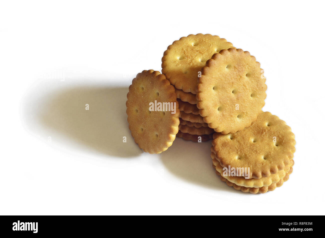 Classic round golden yellow salted cracker isolated on over white ...
