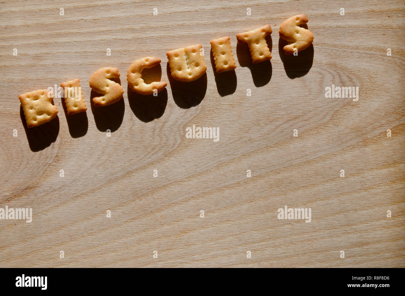 Biscuits. Text from the salty crackers as printed English letters that ...