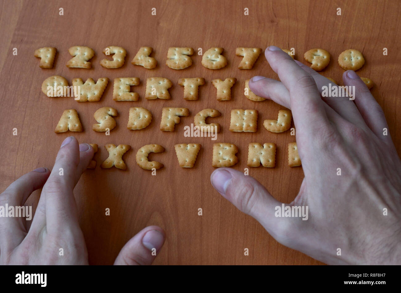 Men's fingers typing on the keyboard, which is composed of salty ...