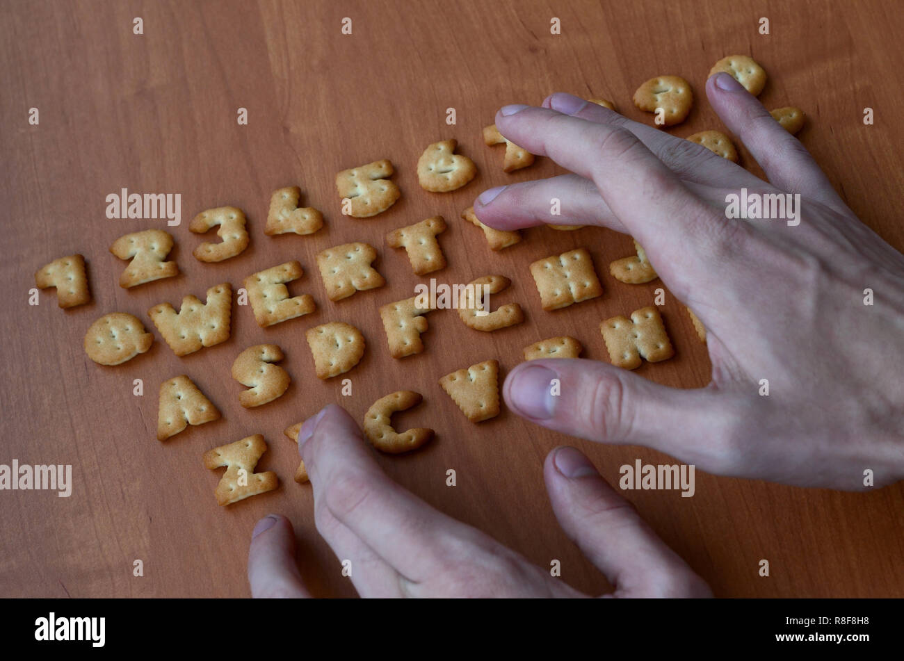 Men's fingers typing on the keyboard, which is composed of salty ...