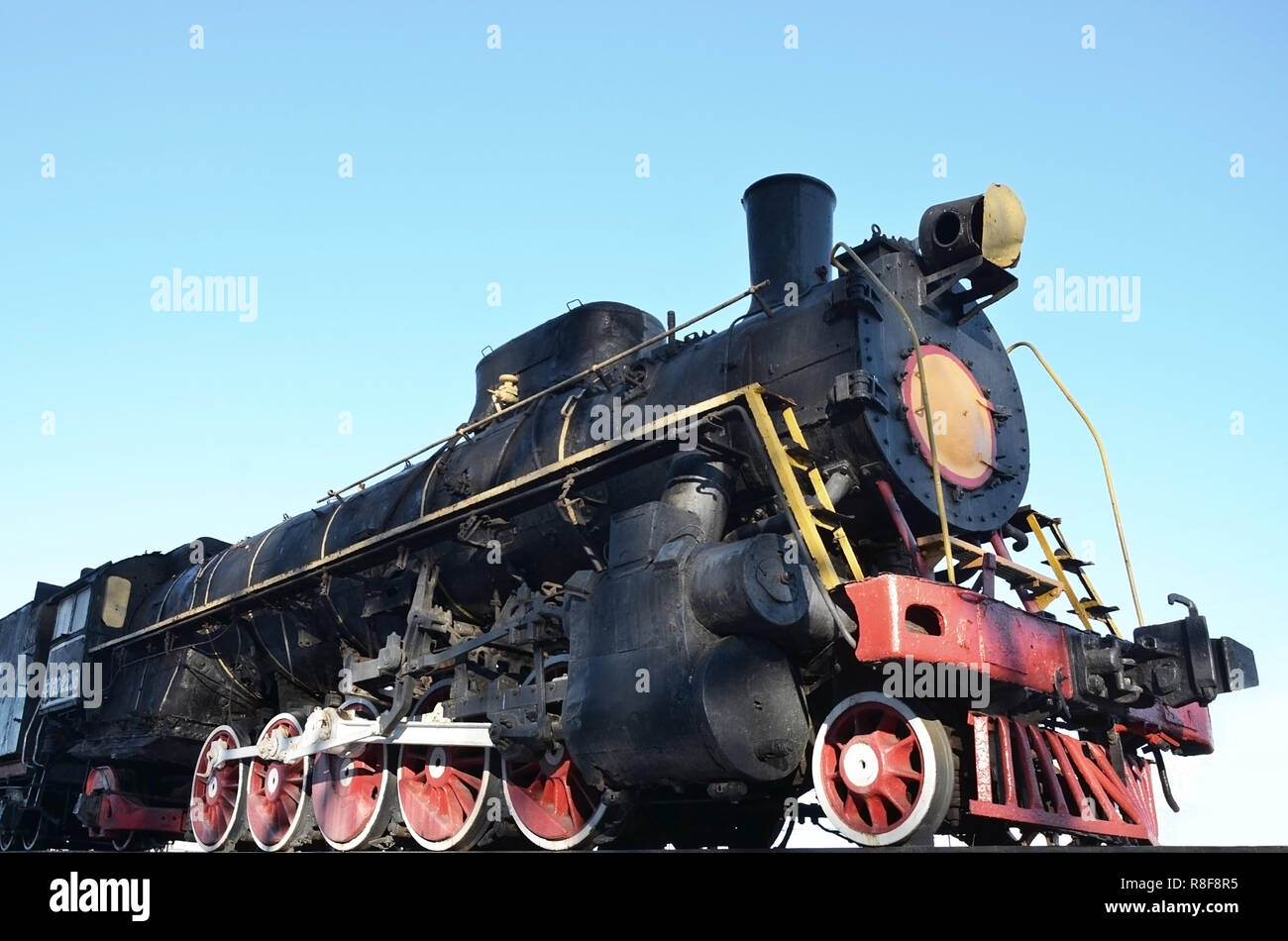 Antique black retro-train on track. A monument to the industrial ...