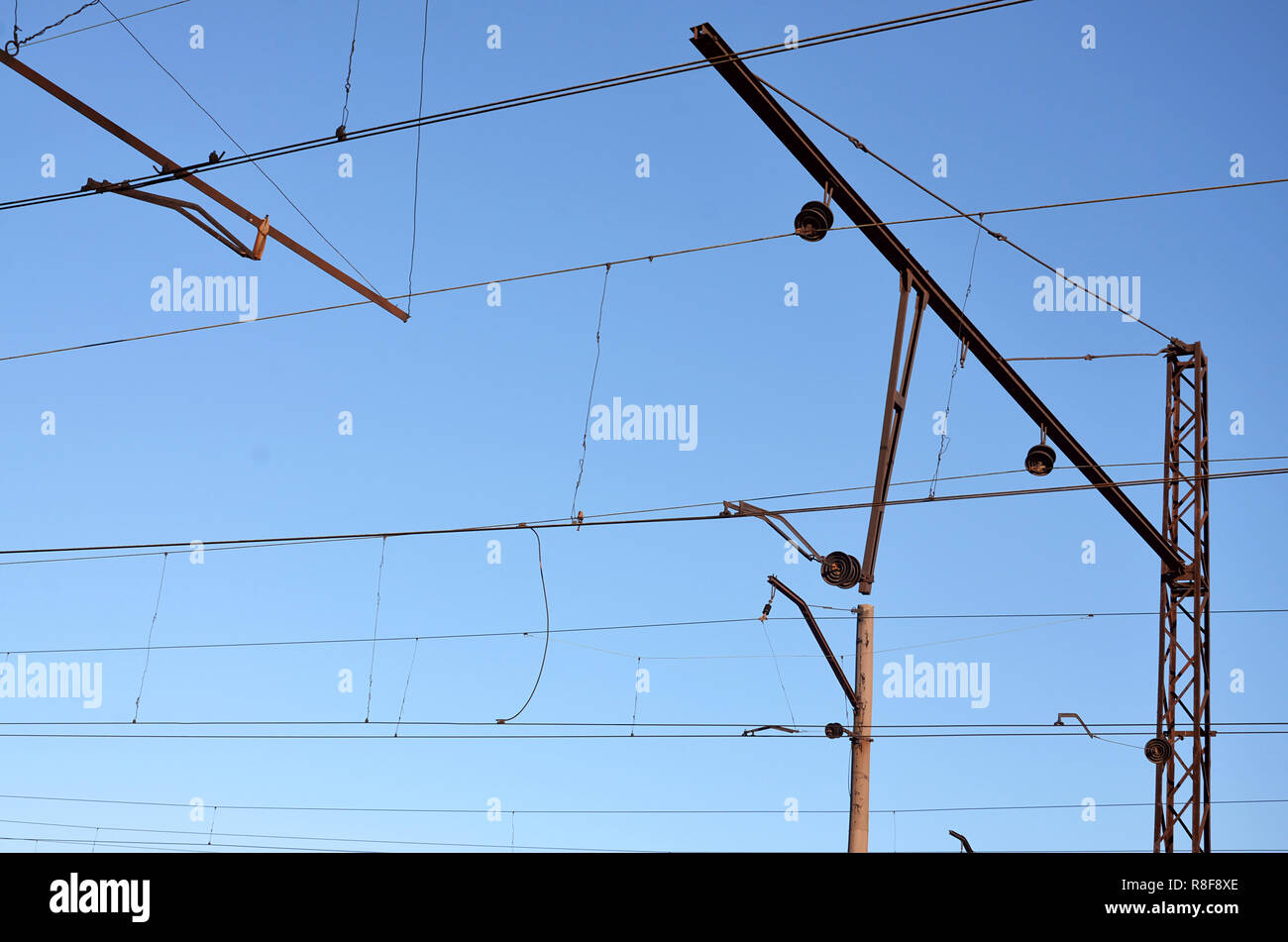 Railroad overhead lines against clear blue sky, Contact wire. High ...